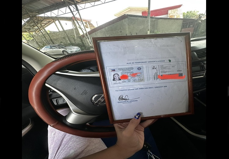 Lady Driver Showcases Her Framed Paper Driver’s License